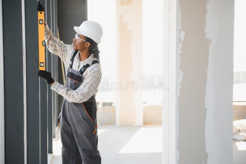 Construction Worker Using Spirit Level on Window Frame at Construction ...
