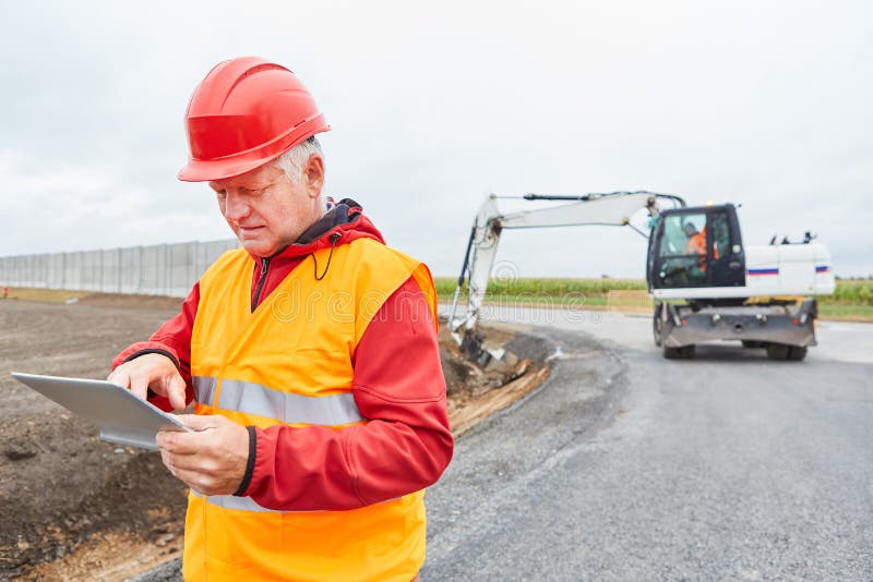 Construction Worker Using Tablet Computer during Construction Planning ...