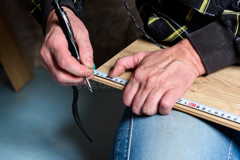 Construction Worker Using Tape Measure Ruler Measuring Laminate Board ...