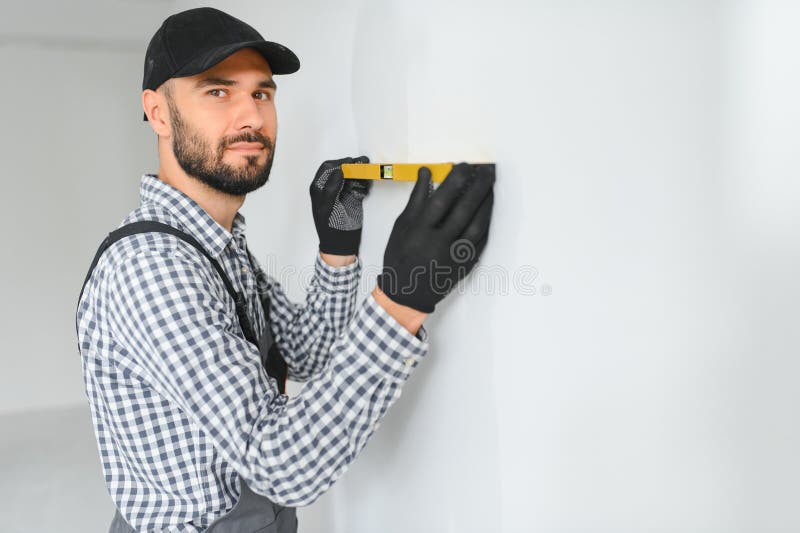 Construction Worker Using a Water Level. Stock Photo - Image of ...