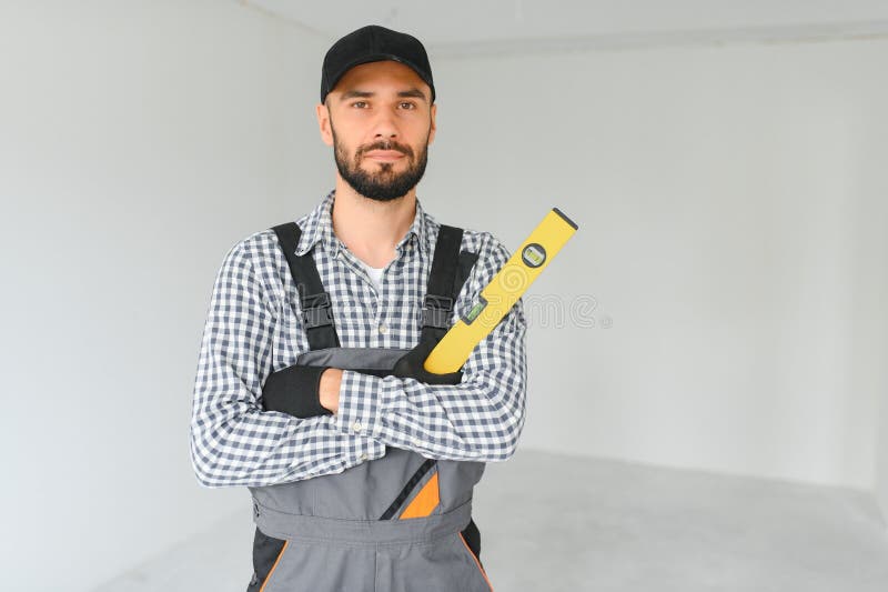 Construction Worker Using a Water Level. Stock Photo - Image of ...