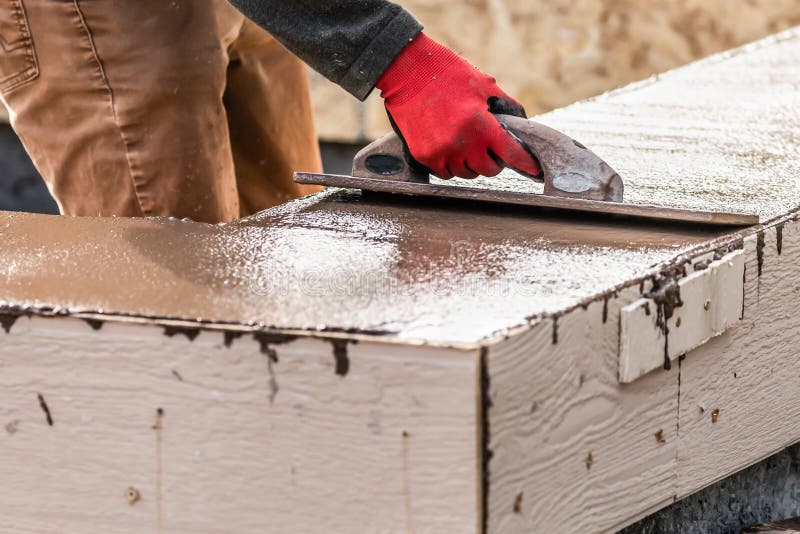 Construction Worker Using Wood Trowel on Wet Cement Forming Coping ...