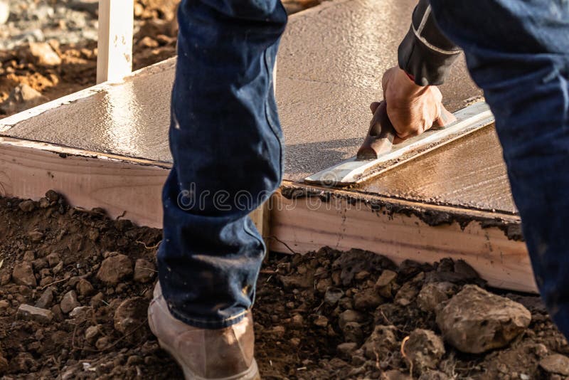 Construction Worker Using Wood Trowel on Wet Cement Forming Coping ...
