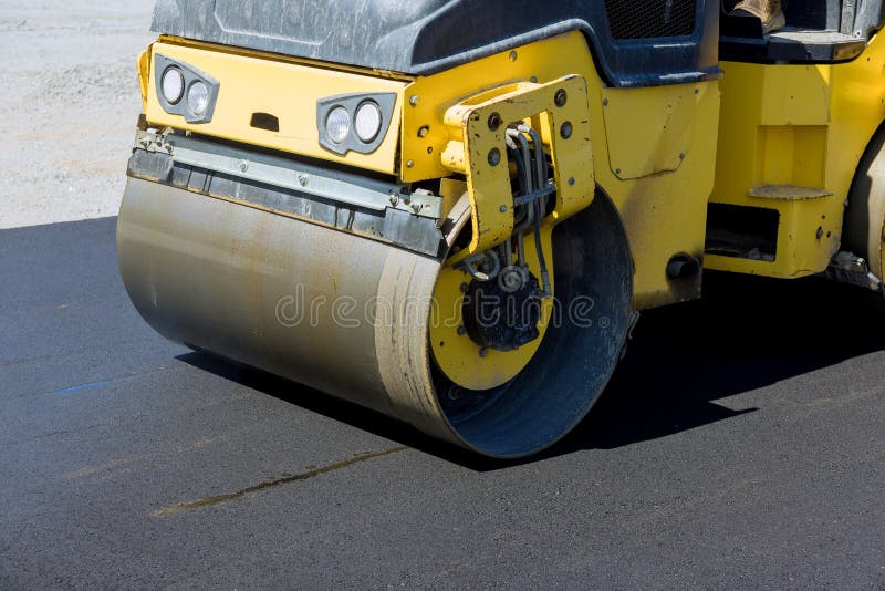 A Construction Worker in a Vibratory Road Roller Compactor Machine ...