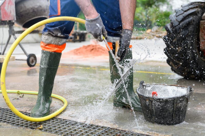 Construction Worker Washing Tools at Construction Site Road Street ...