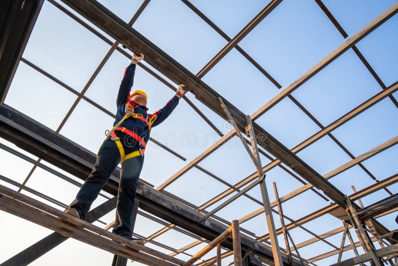 A Construction Worker Wearing Fall Arrestor Device for Worker with ...