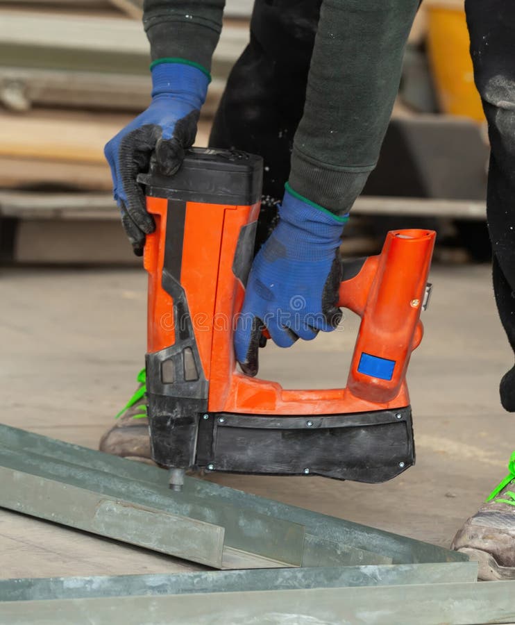 Construction Worker Using Nail Gun on Metal Profile Stock Image - Image ...