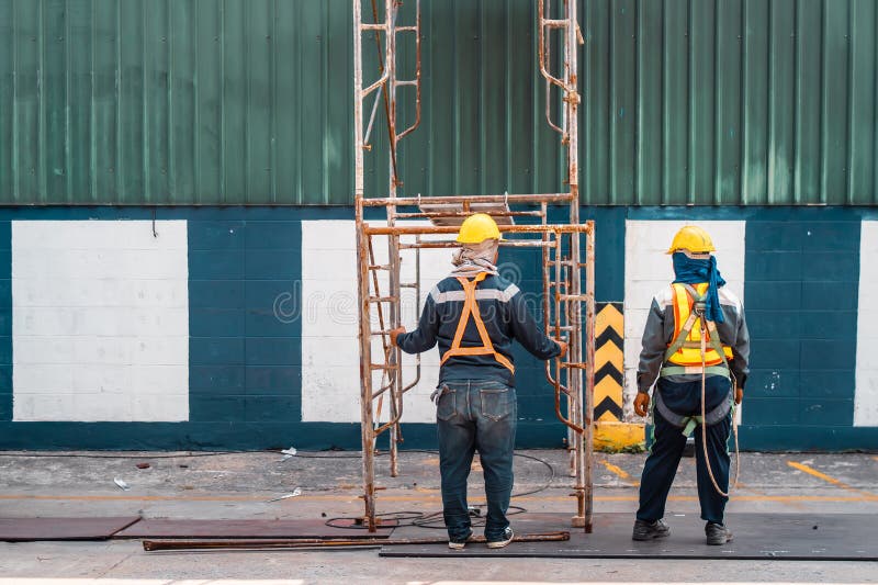 Construction Worker Wearing Safety Harnesses with Scaffolding at ...