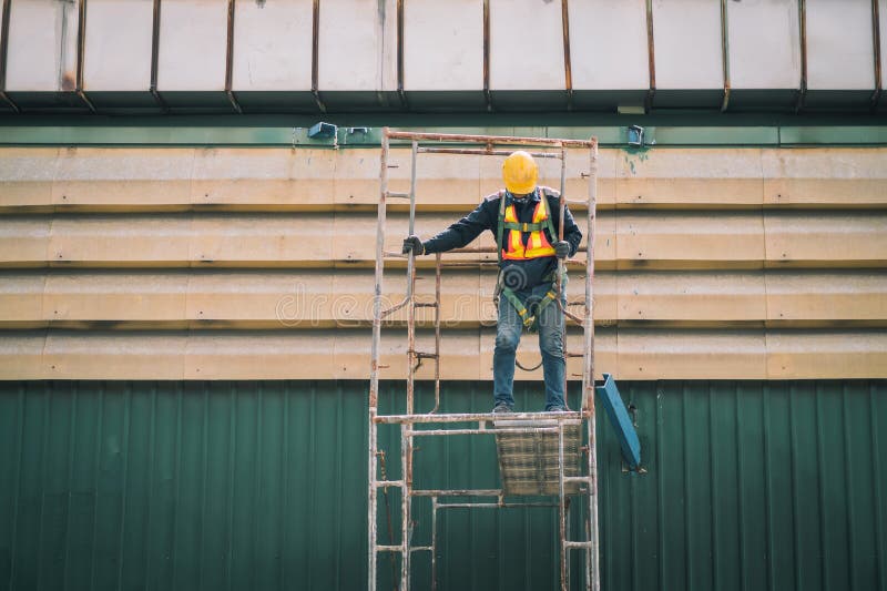 Construction Worker Wearing Safety Harness Belt during Working on Roof ...