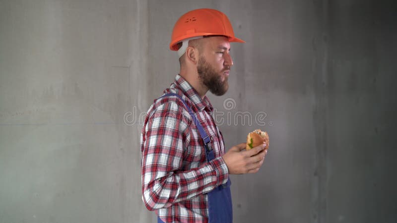 Construction Worker Wearing Uniform Eating Burger during Lunch Break ...