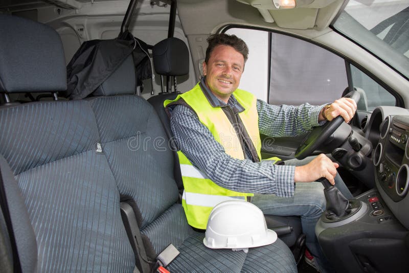 Construction Worker, Wearing a White Helmet in a Car Driving Stock ...