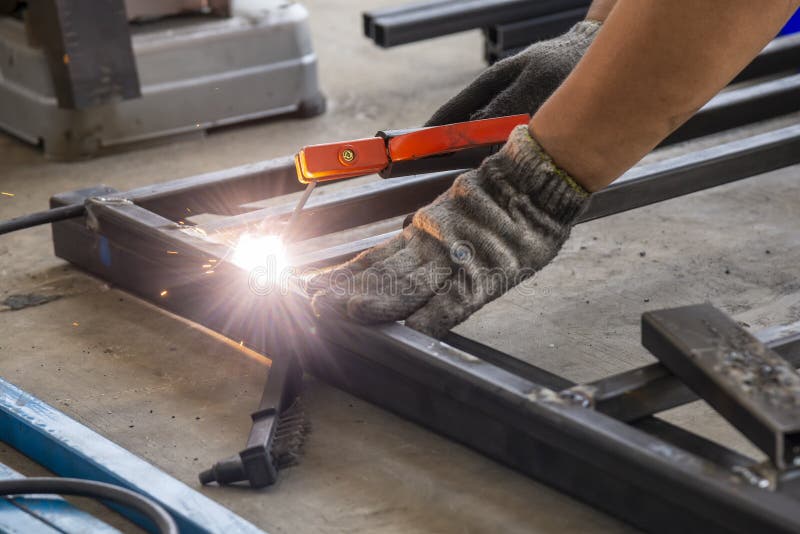 The Construction Worker Welding the Metal Tube . Stock Photo - Image of ...