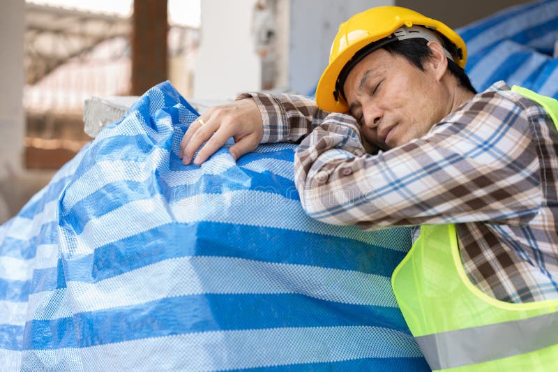Construction Worker with White Safety Helmet Take a Nap because so are ...