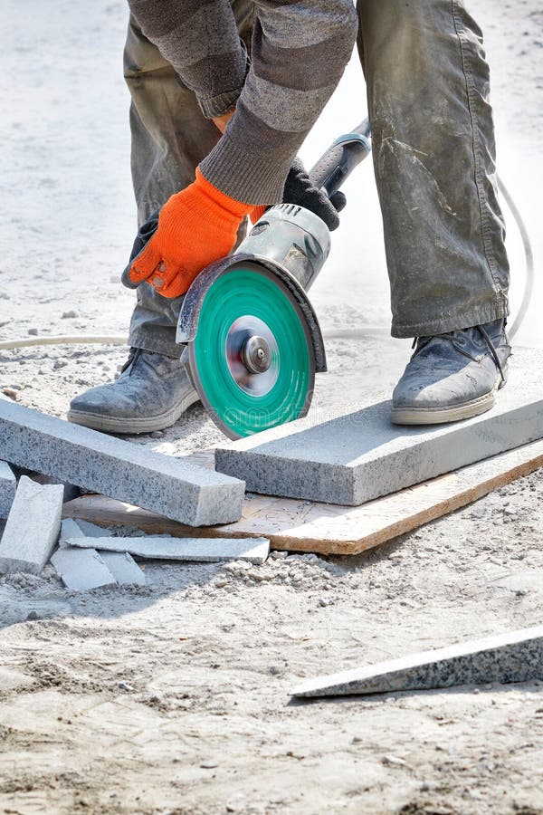 A Builder Uses a Grinder and Diamond Cutting Disc To Cut Granite Blocks ...