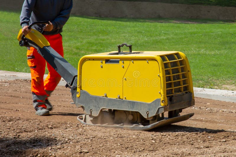 Construction Worker Work Hardens Sandy Ground Vibratory Plate Stock ...