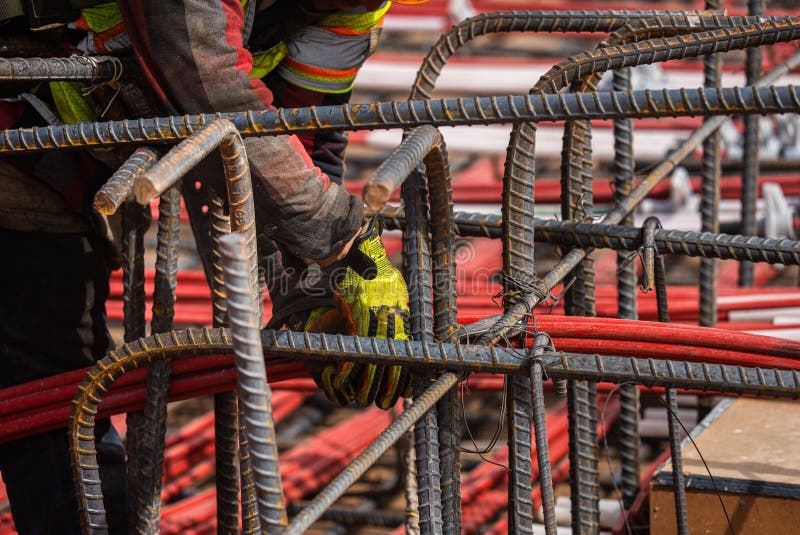 The Construction Worker is Working on the Large Steel Bars at the ...