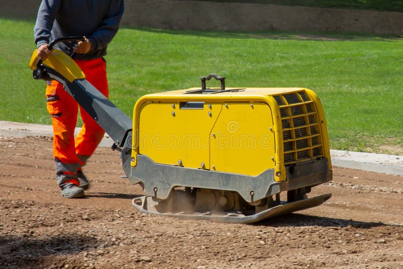 Construction Worker Working on the Road with a Vibratory Plate Stock ...