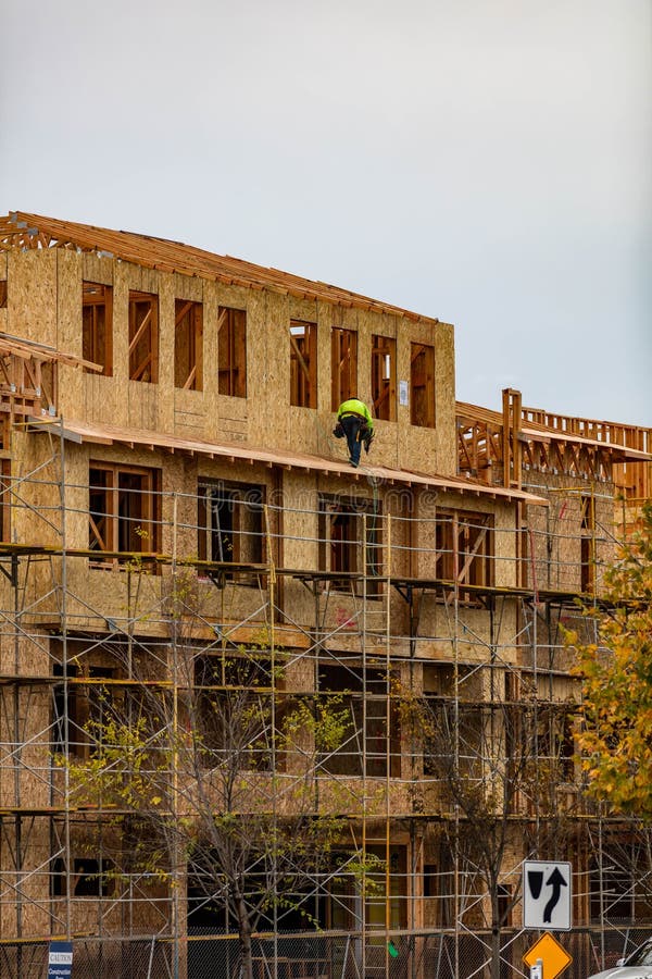 A Construction Worker Working on Scaffolding on a Construction Site ...