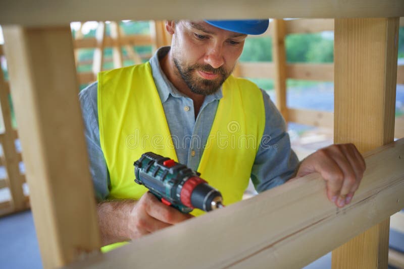 Construction Worker Working with Screwdriver on Wooden Frame, Diy Eco ...
