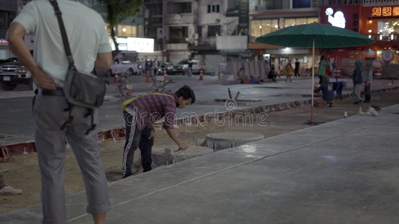 A Construction Worker Working on a Street Reconstruction. he is ...