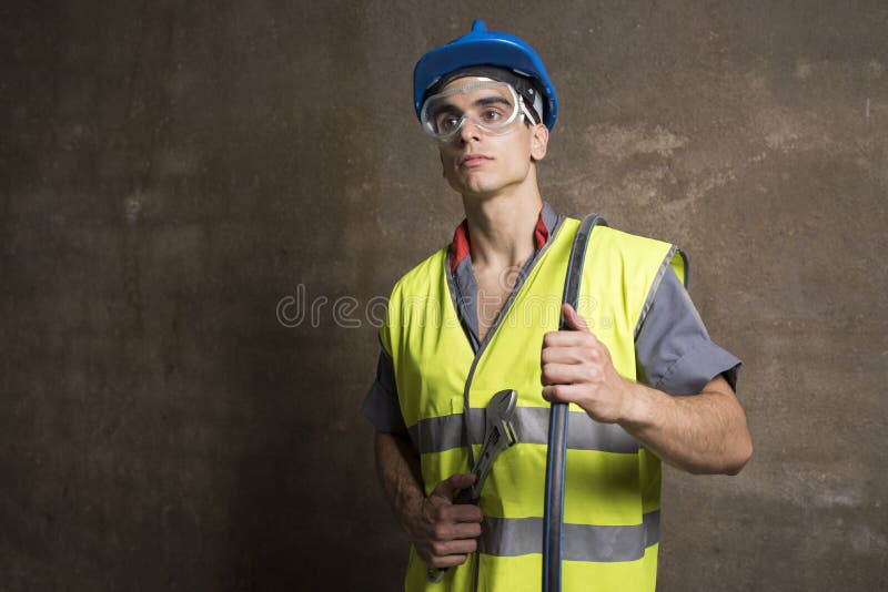 Construction Worker with Wrench and Protective Eyeglasses in Studio ...