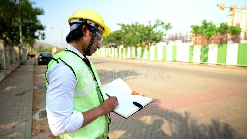 Construction Worker Writing in a Notebook on Site Stock Video - Video ...