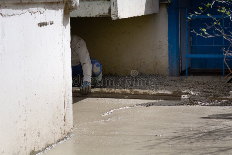 Construction Workers Aligns Concrete Screed. Construction, Foundation ...