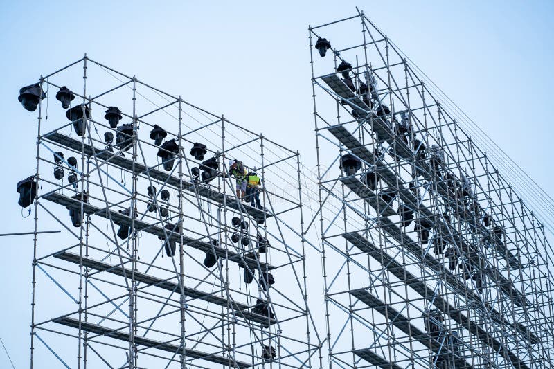 Construction Workers Assembling Large Scaffolding and Metal Rigs for ...