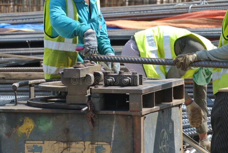 Bending Reinforcement Metal Rebar. Worker Using Bending Rebar Machine ...