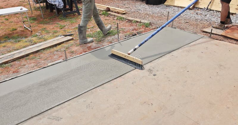 Construction Workers Brush Freshly Poured Concrete with a Broom ...
