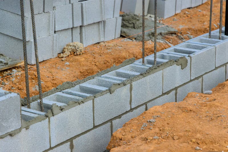 Construction Workers Build Sturdy Base with Concrete Blocks at Building ...