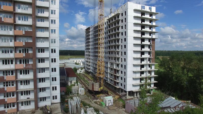 Construction Workers Building an Apartment Building in a Field, Aerial ...