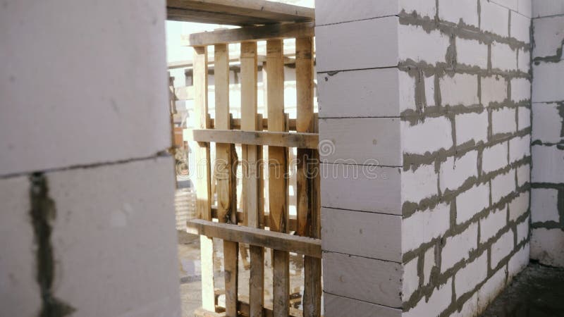 Construction Workers Building Walls with White Bricks. Stock Image ...