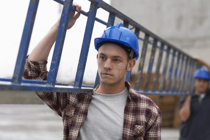 Side View of Construction Workers Carrying Ladder Stock Image - Image ...