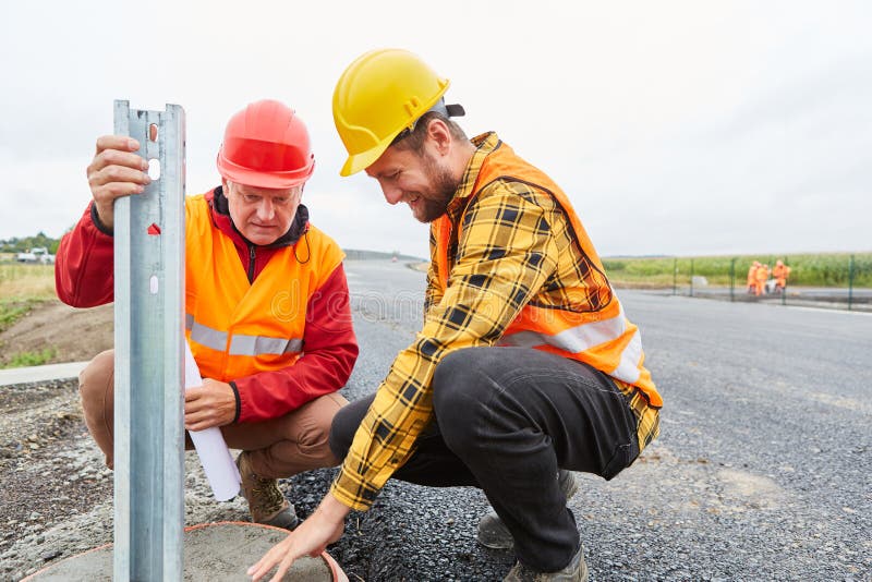 Construction Workers Check Foundation for Guard Rails Stock Photo ...