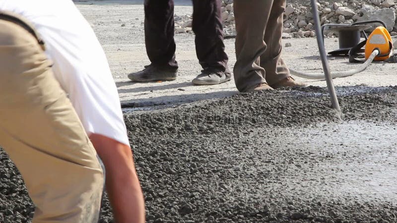 Construction Workers Compacting Liquid Cement into a Runway ...