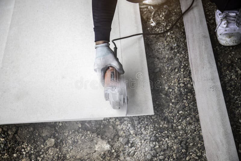 Construction Workers with Cutter Cutting Gypsum Board for Ceilings on ...