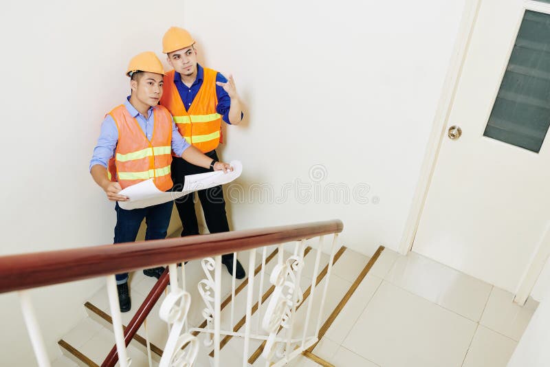 Construction Workers Discussing Flight of Stairs Stock Photo - Image of ...