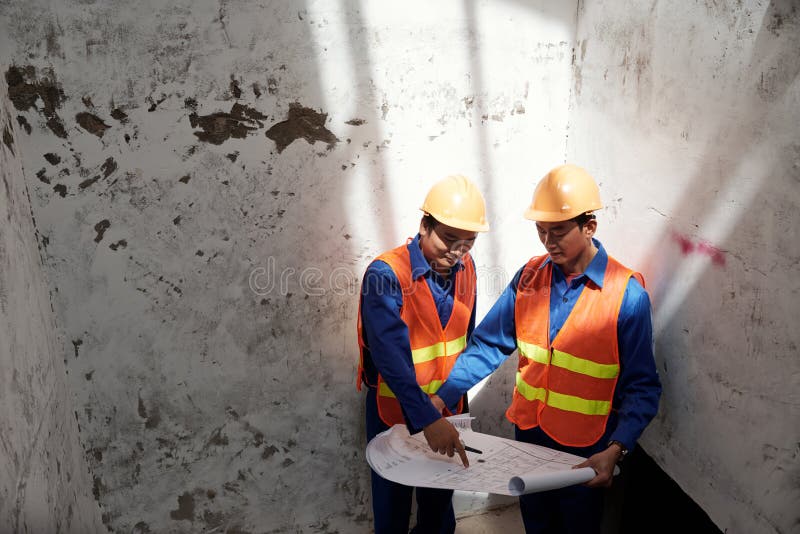 Construction Workers Discussing Project Stock Photo - Image of serious ...