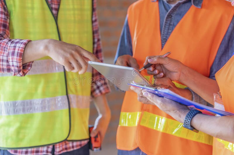 Construction Workers Discussion Routine Inspection with Document and ...