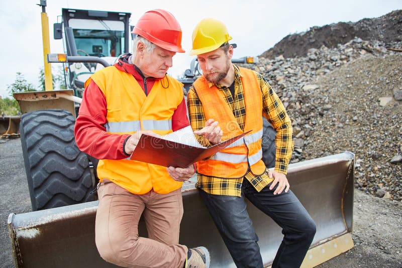 Construction Workers in Front of a Wheel Loader when Planning House ...