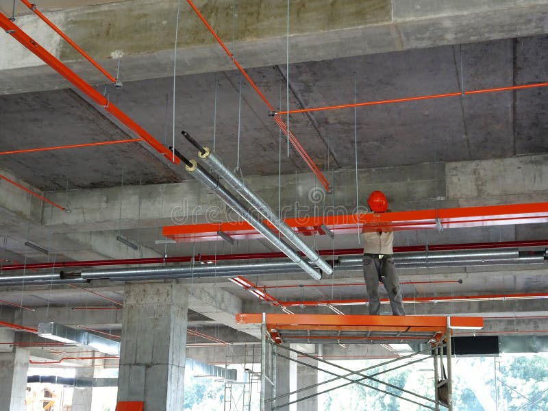 Construction Workers Installing Electrical Cable Tray and Doing Wiring ...