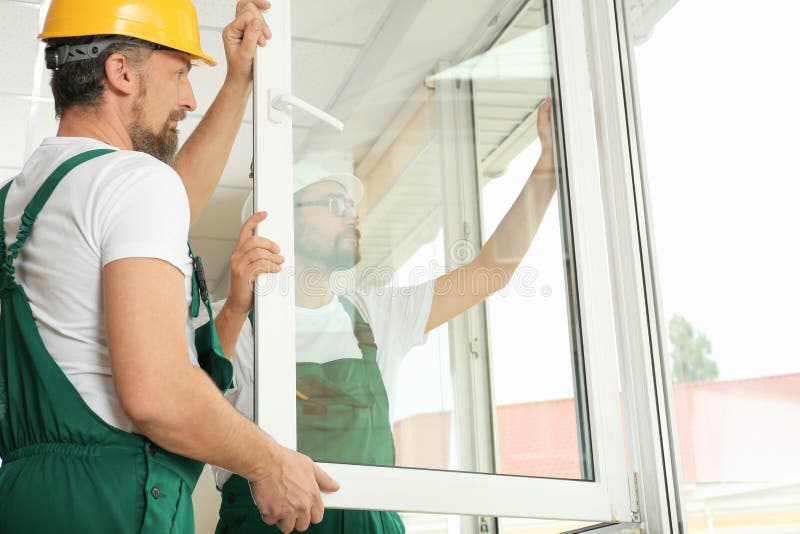 Construction Workers Installing New Window Stock Image - Image of glass ...