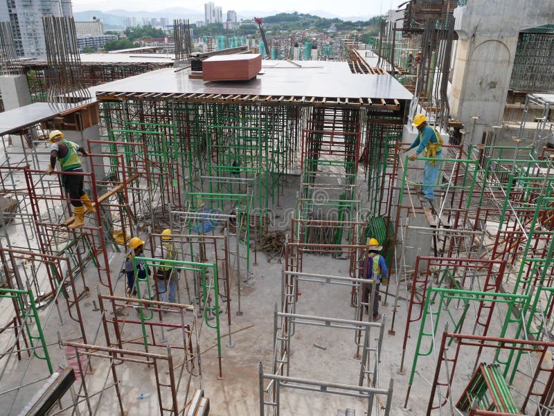 Construction Workers are Installing Scaffolding at a Construction Site ...