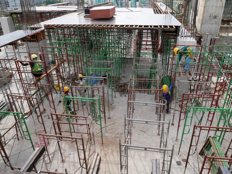 Construction Workers are Installing Scaffolding at a Construction Site ...