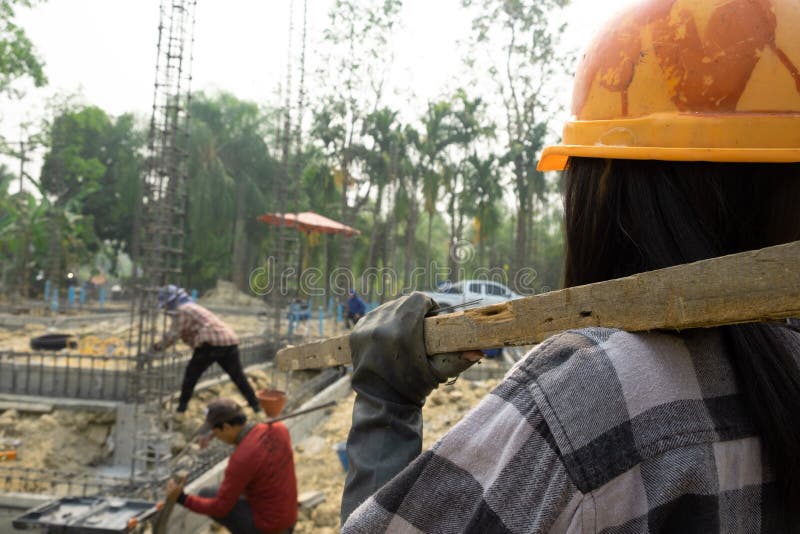 Construction Laborer Team Working On High Ground Building Housing In ...