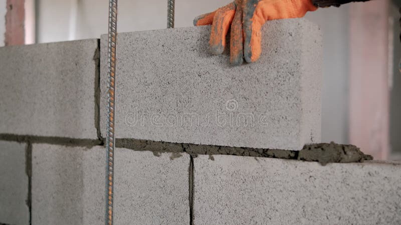 Construction Worker Laying Concrete Blocks Using Mortar of Cement and ...