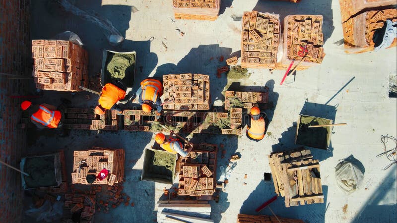 Construction Workers Laying Bricks on a Building Site. a Top-down View ...