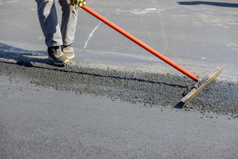 Construction Workers Laying New Asphalt Roads in the Middle of the ...
