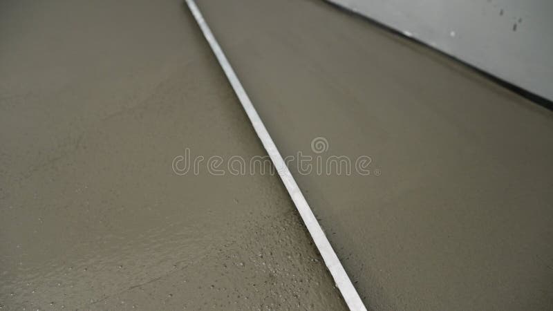 Construction Workers Leveling Wet Concrete Using a Bull Float Stock ...